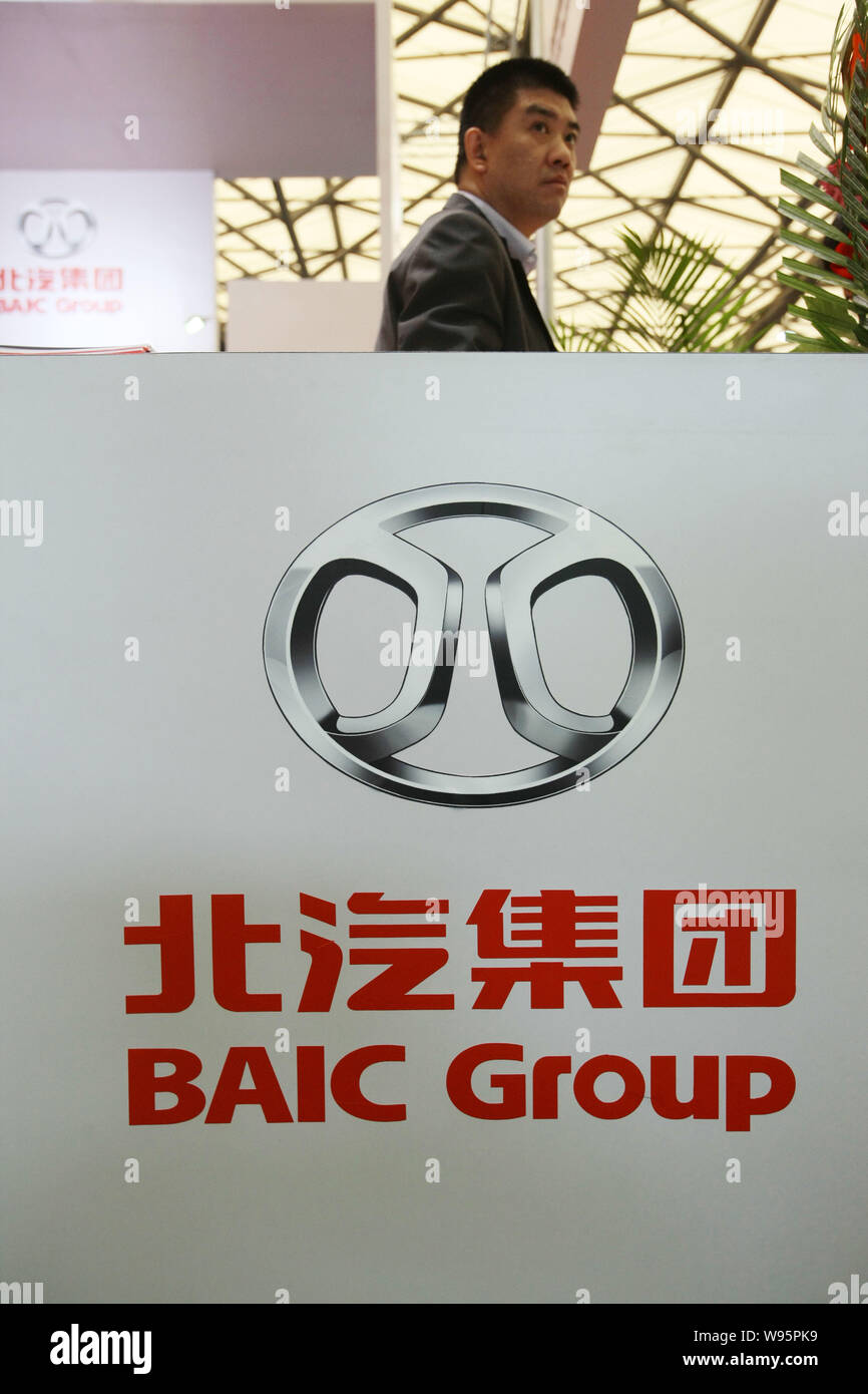 --FILE--A visitor walks past the stand of BAIC Group in an exhibition ...