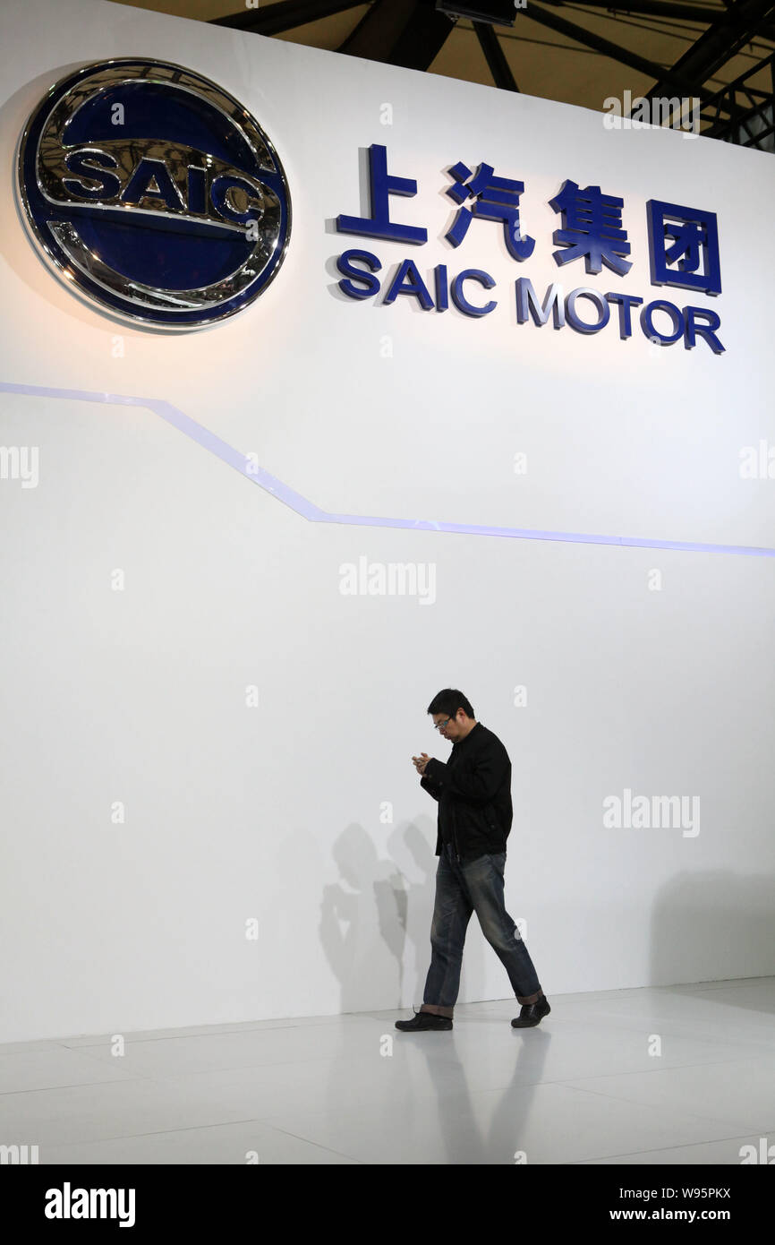 --FILE--A visitor walks past the stand of SAIC Motor during the 14th ...