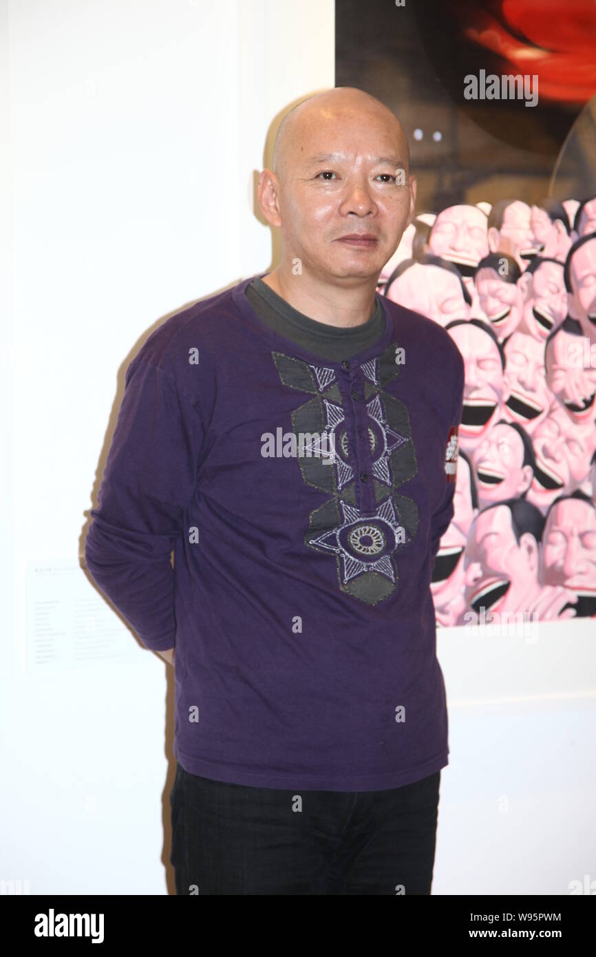 Chinese contemporary artist Yue Minjun poses during the opening ...