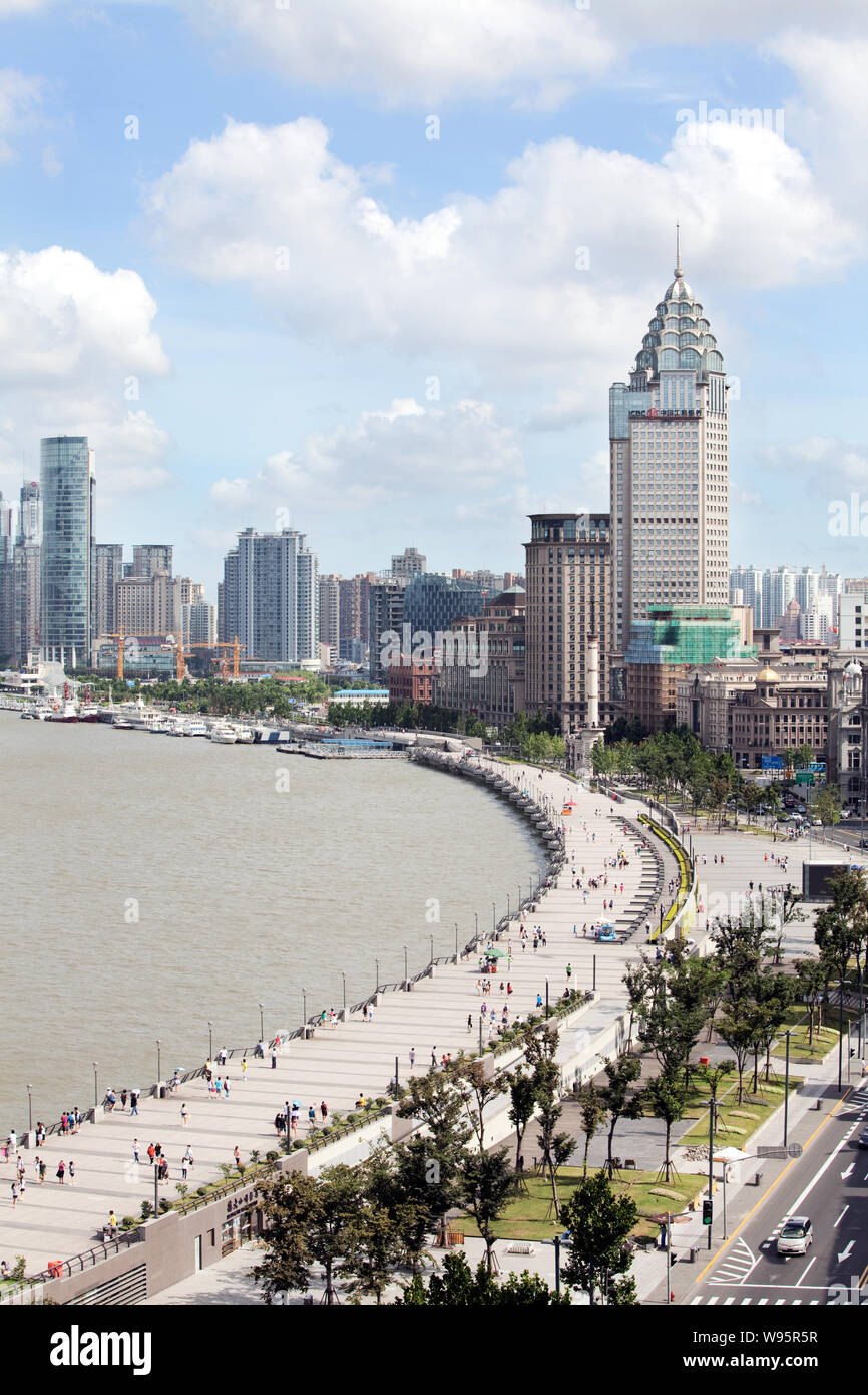 Tourists visit the promenade on the Bund along Huangpu River in Puxi ...