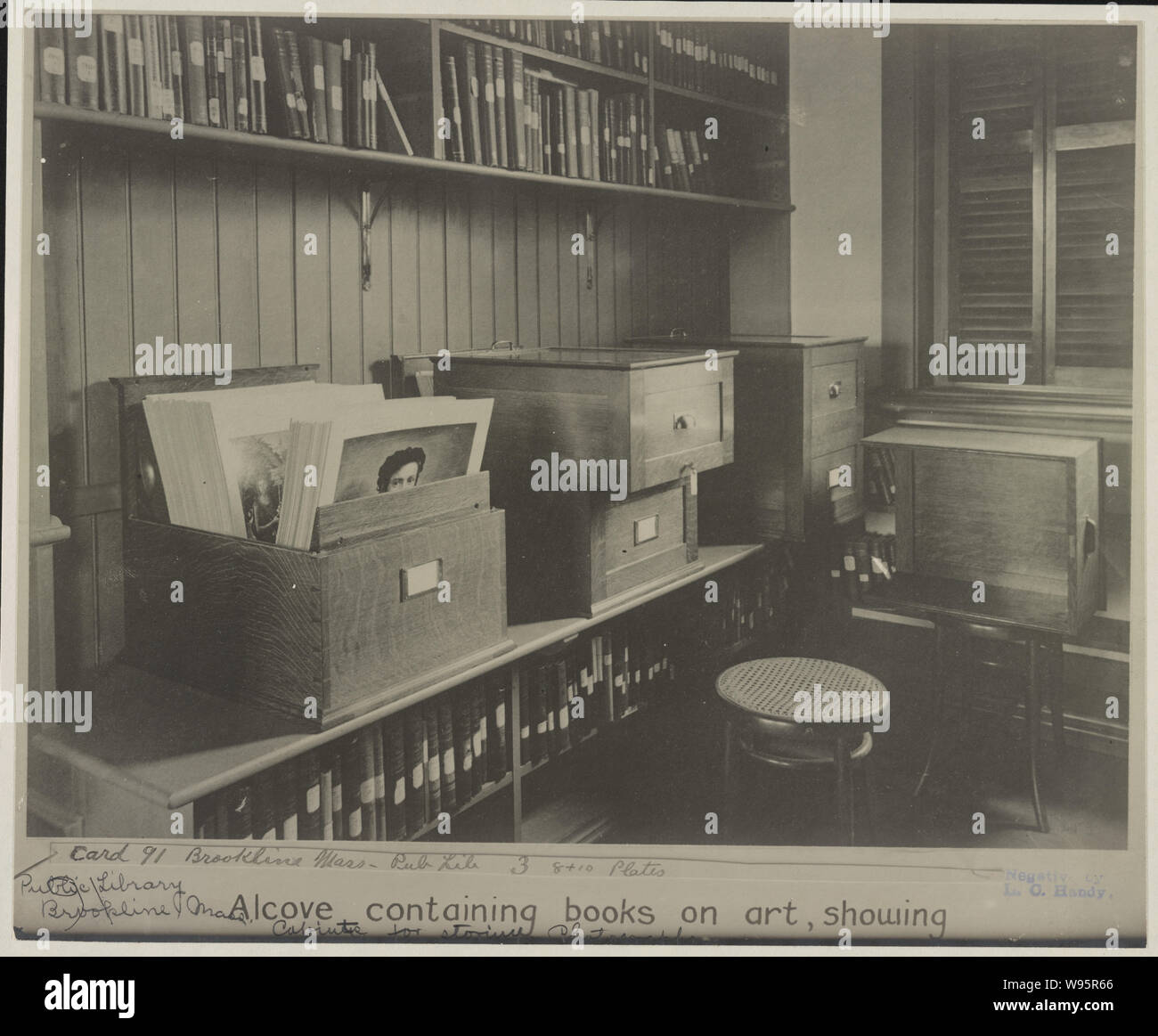 Alcove containing books on art, showing cabinets for storing ...