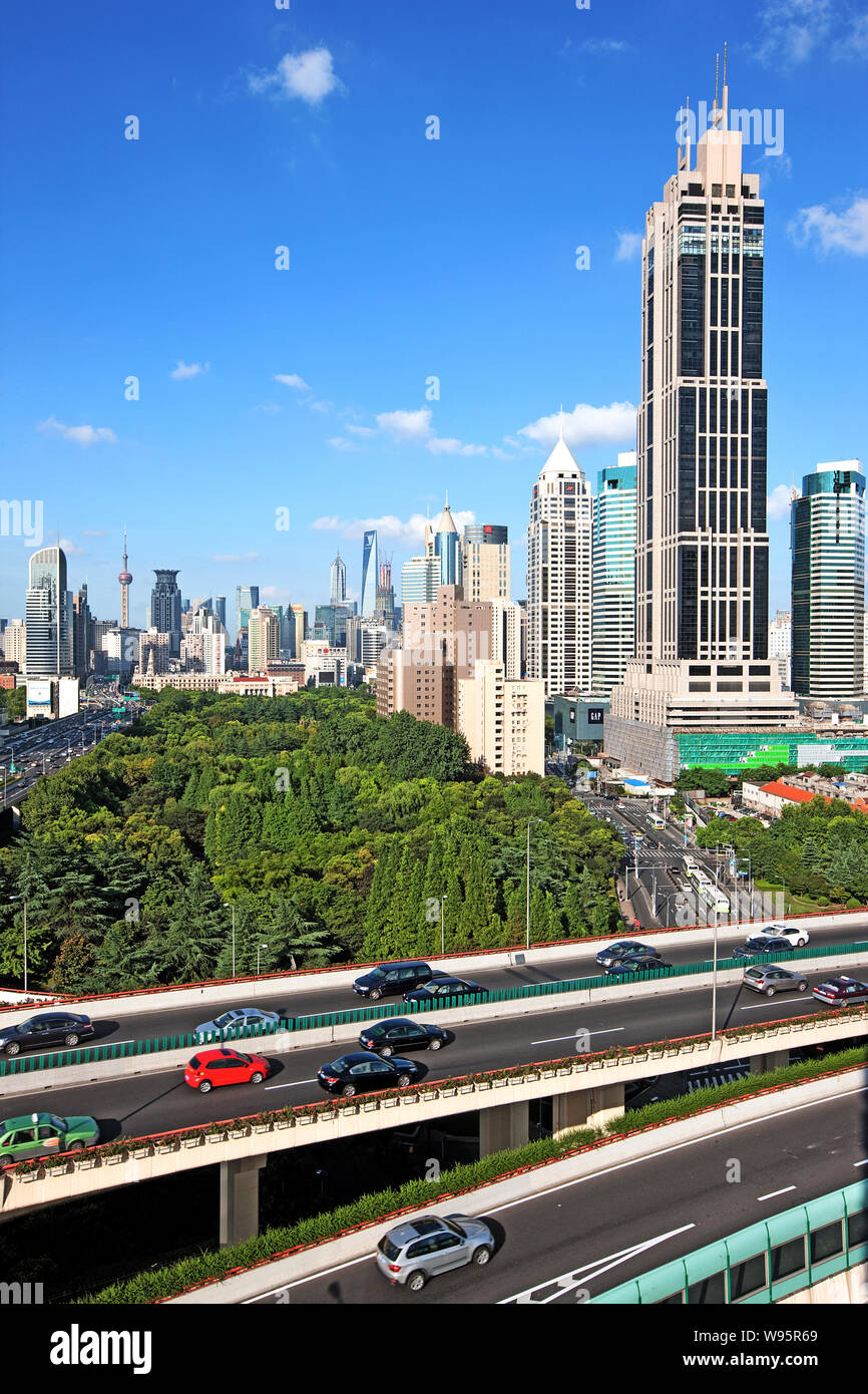 Cars travel on elevated highways against the skyline of Puxi and Pudong ...