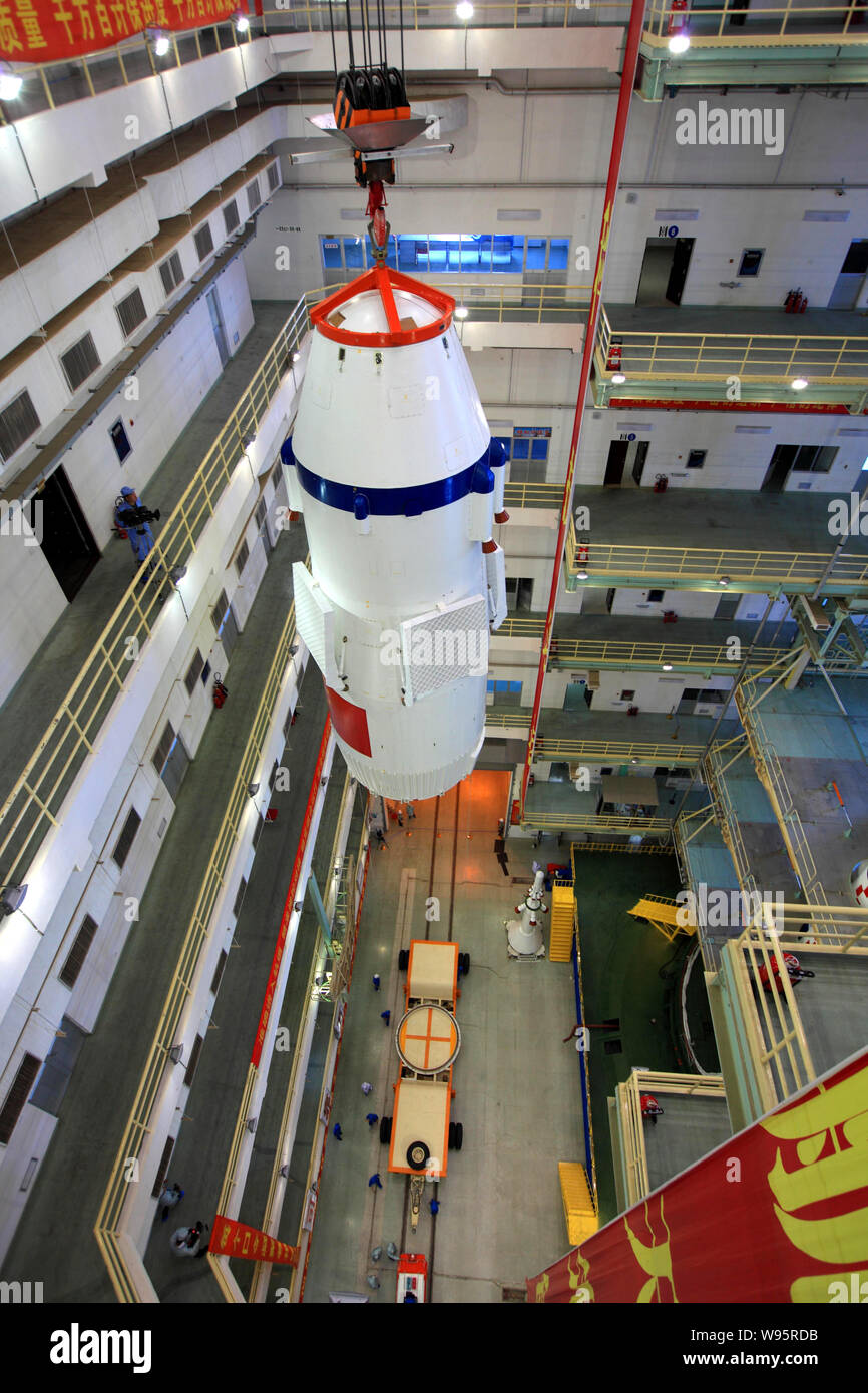 The Shenzhou-9 (Shenzhou IX) spacecraft is being lifted before being ...