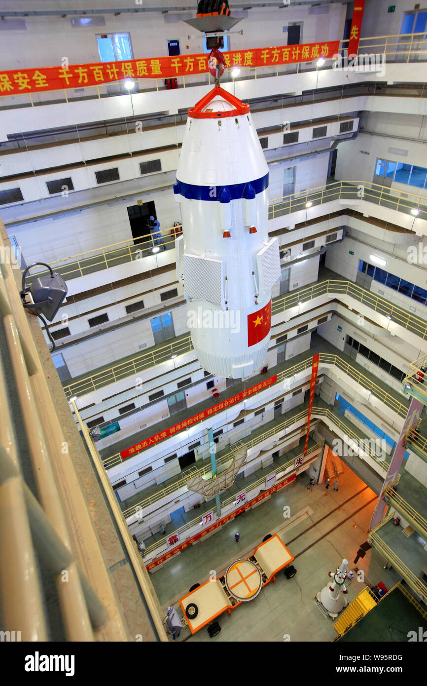 The Shenzhou-9 (Shenzhou IX) spacecraft is being lifted before being ...