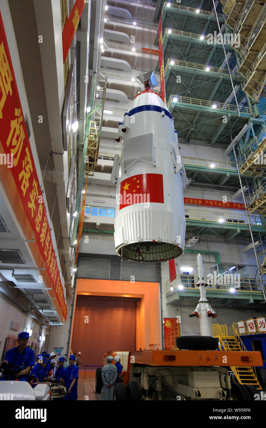 The Shenzhou-9 (Shenzhou IX) spacecraft is being lifted before being ...