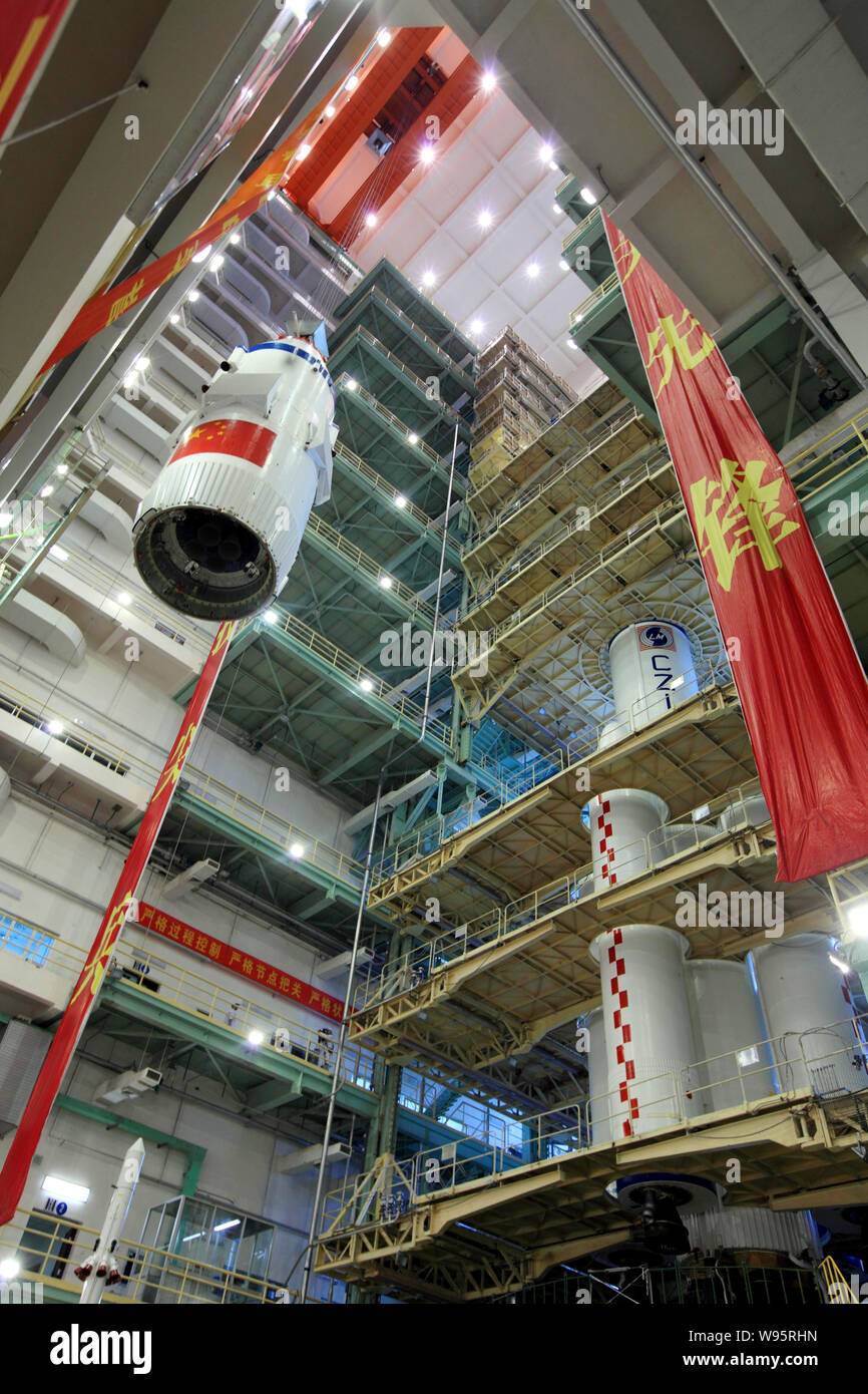 The Shenzhou-9 (Shenzhou IX) spacecraft is being lifted before being ...