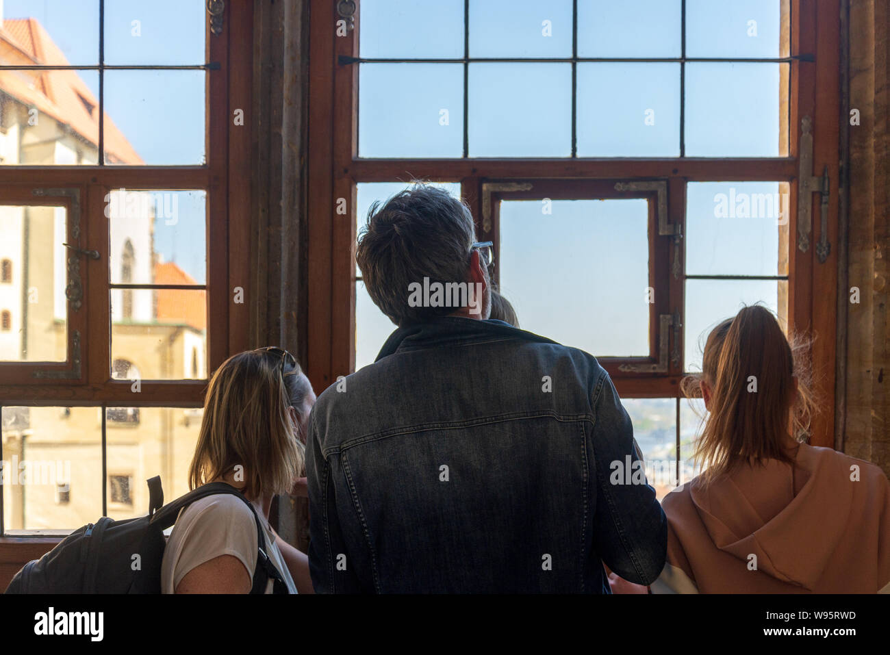 Group of people look at the windows of Old Royal Palace, in Praha ...