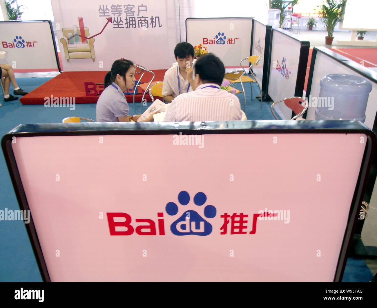 --File--Chinese staff are seen at the stand of Baidu during a fair in ...