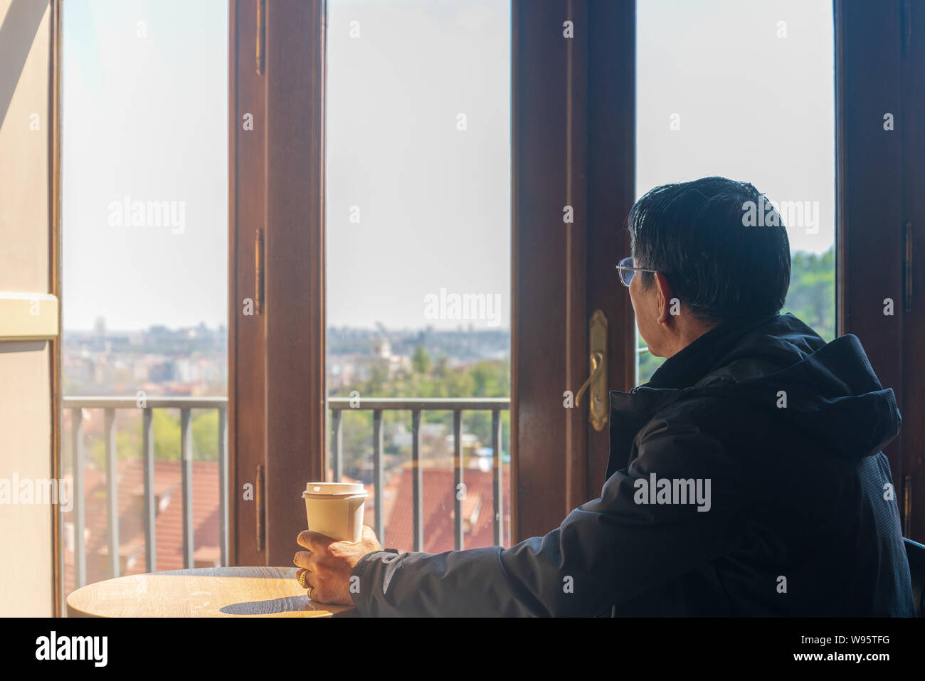 Back of person looking in shop window hi-res stock photography and ...