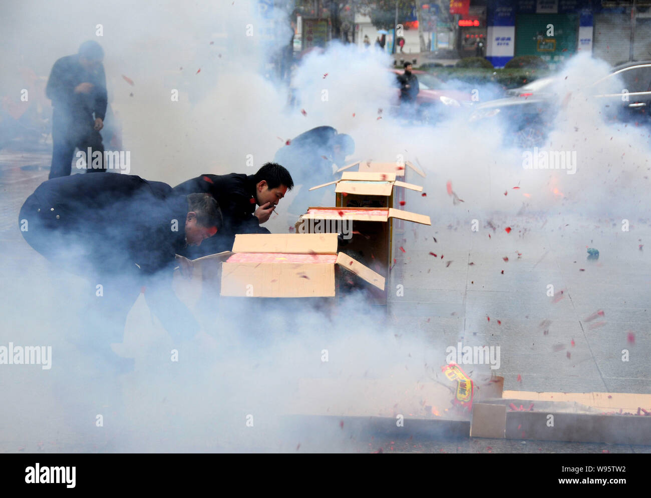 Chinese men ignite firecrackers and fireworks in dense smoke during the ...