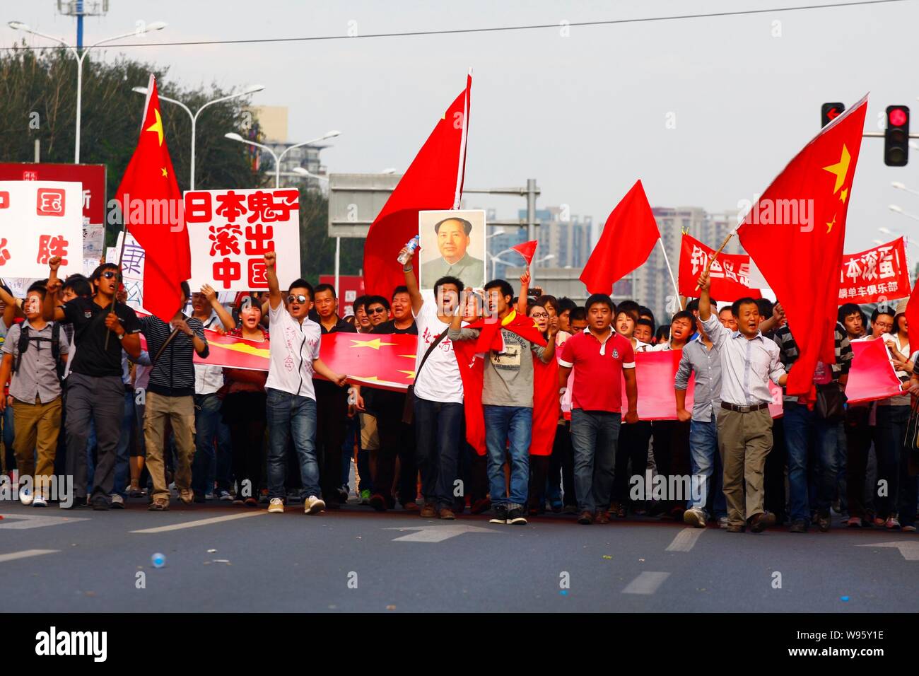 Chinese protestors wave Chinese national flags, hold up banners and ...