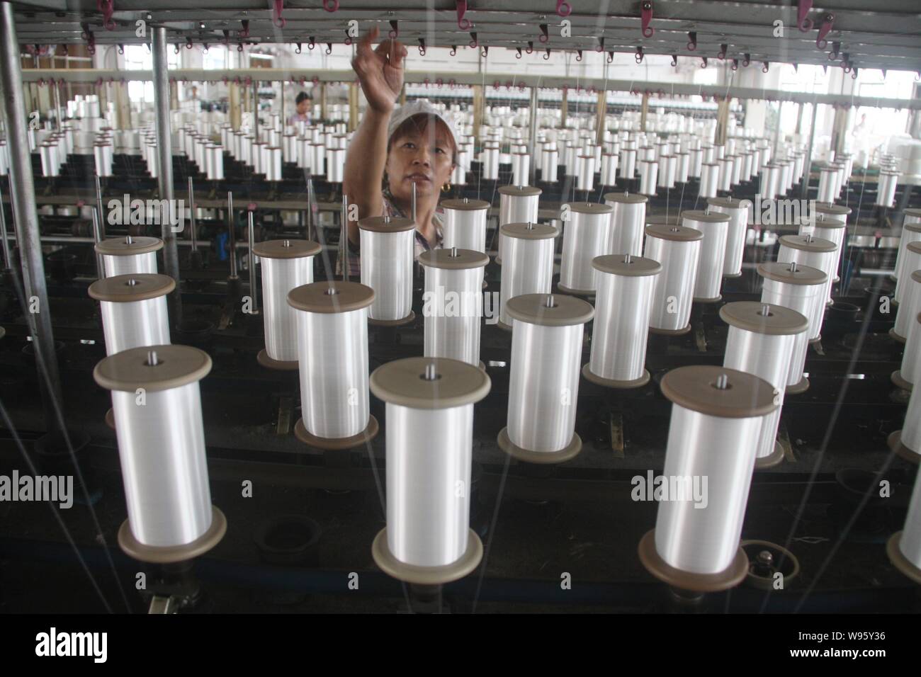 --FILE--A female Chinese worker handles the production of chemical ...