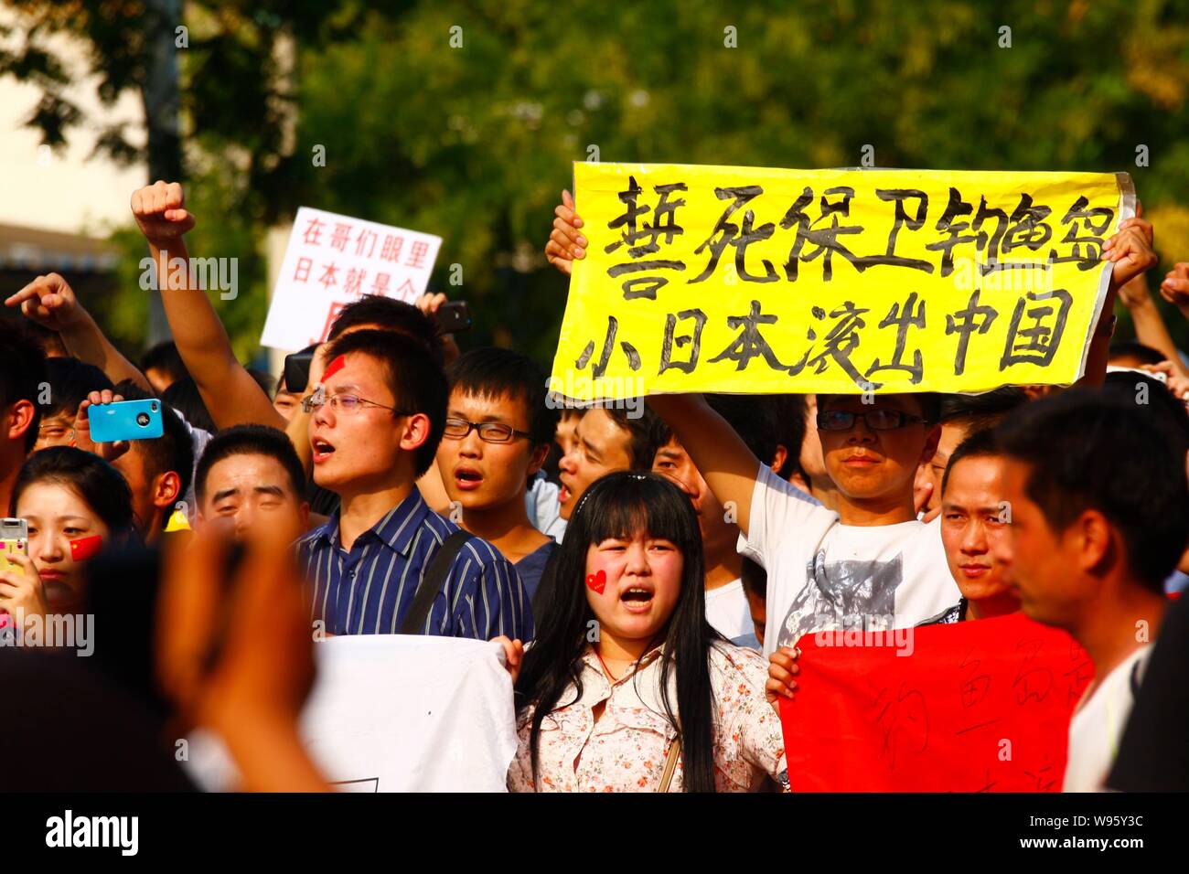 Chinese protestors hold up banners and shout slogans during an anti ...