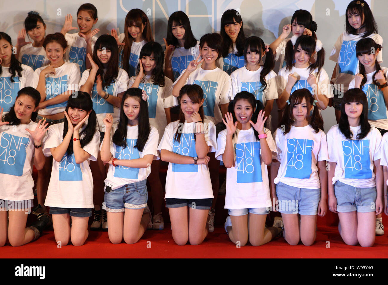 Young girls of Chinese pop group SNH48 attend a ceremony in Shanghai ...