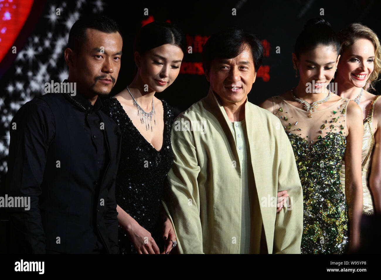 Famous action star Jackie Chan (M) poses with cast member of his new ...