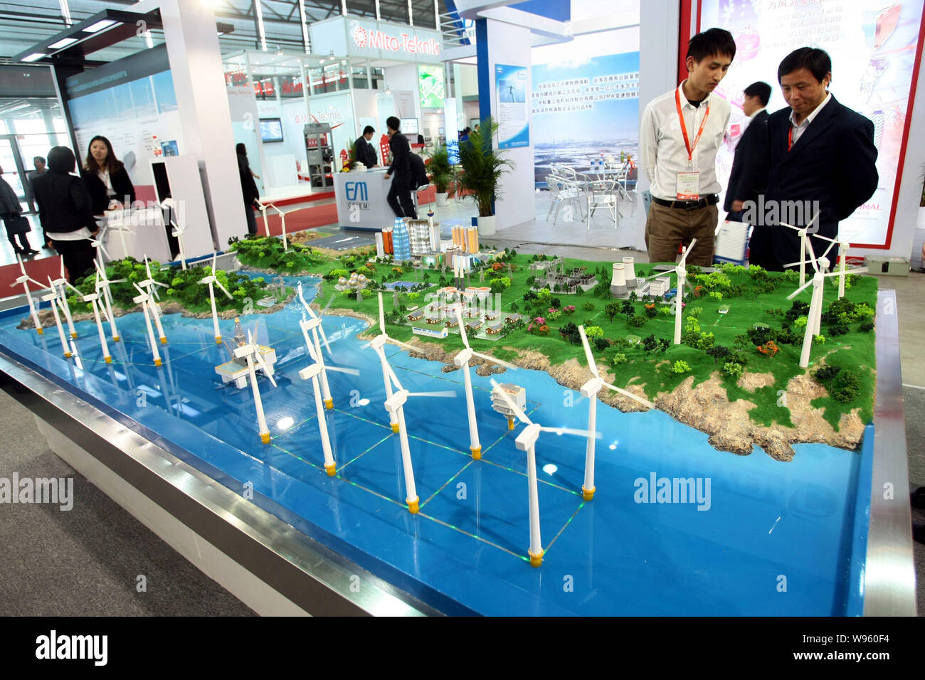 Visitors look at models of a wind farm during the 6th China (Shanghai ...