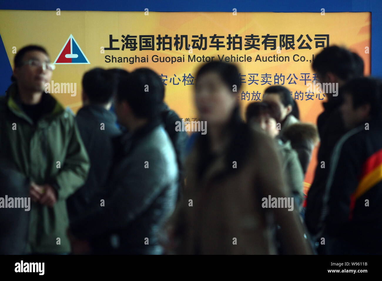 Car license plate applicants are seen in the hall of the pay center for ...
