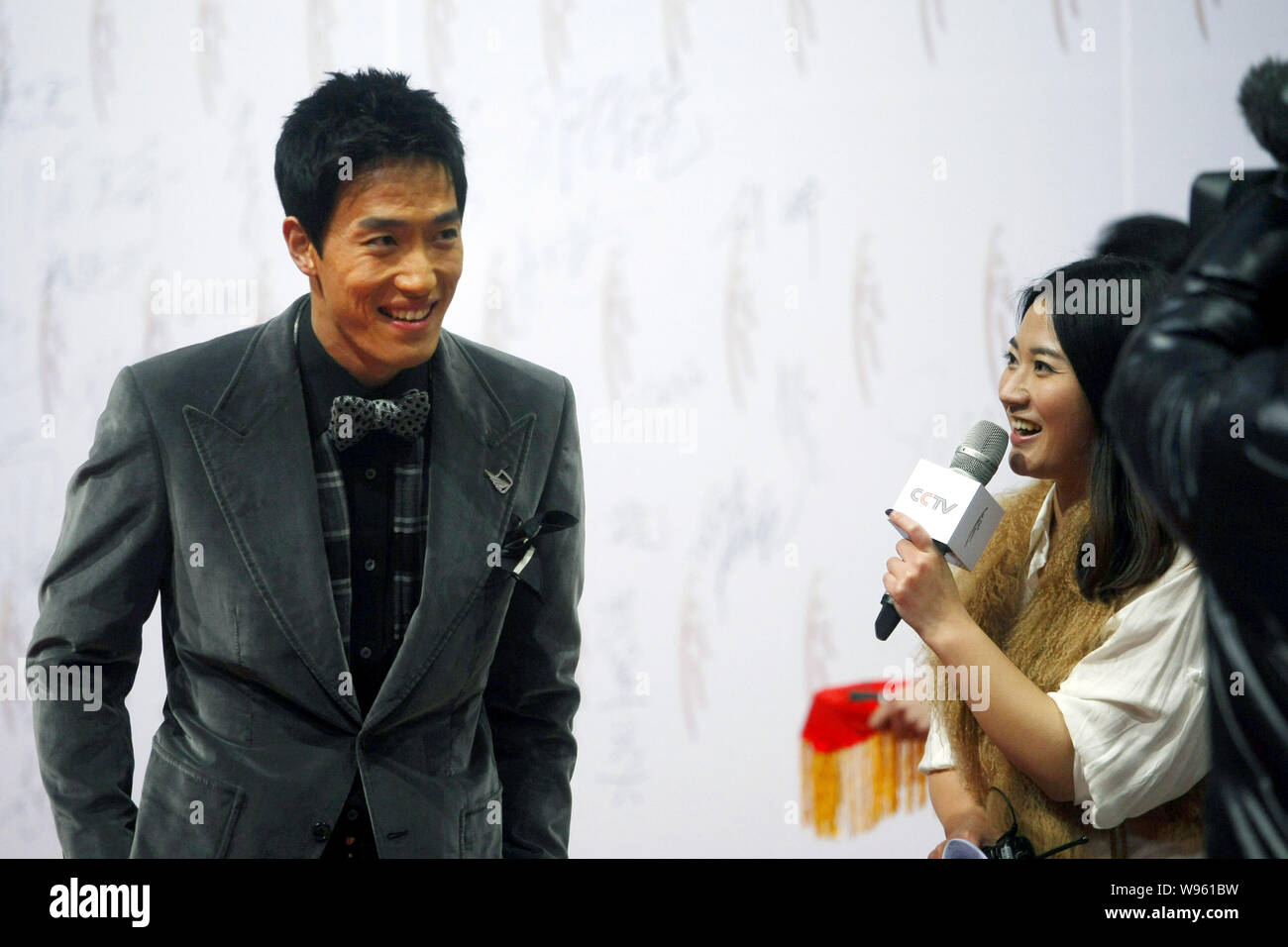 Chinese star hurdler Liu Xiang is interviewed on the red carpet before ...