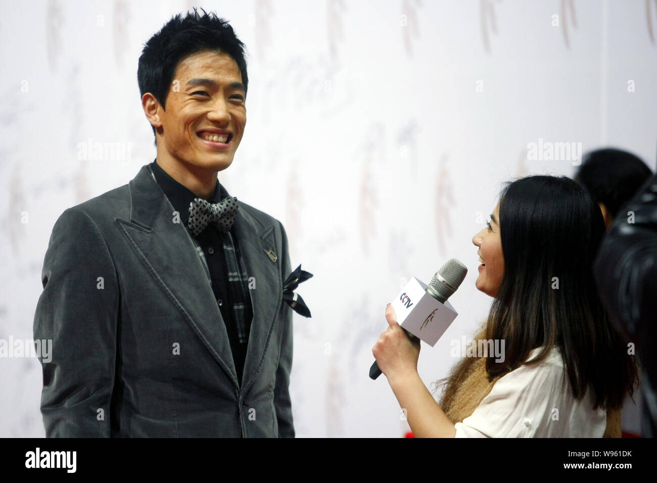 Chinese star hurdler Liu Xiang is interviewed on the red carpet before ...