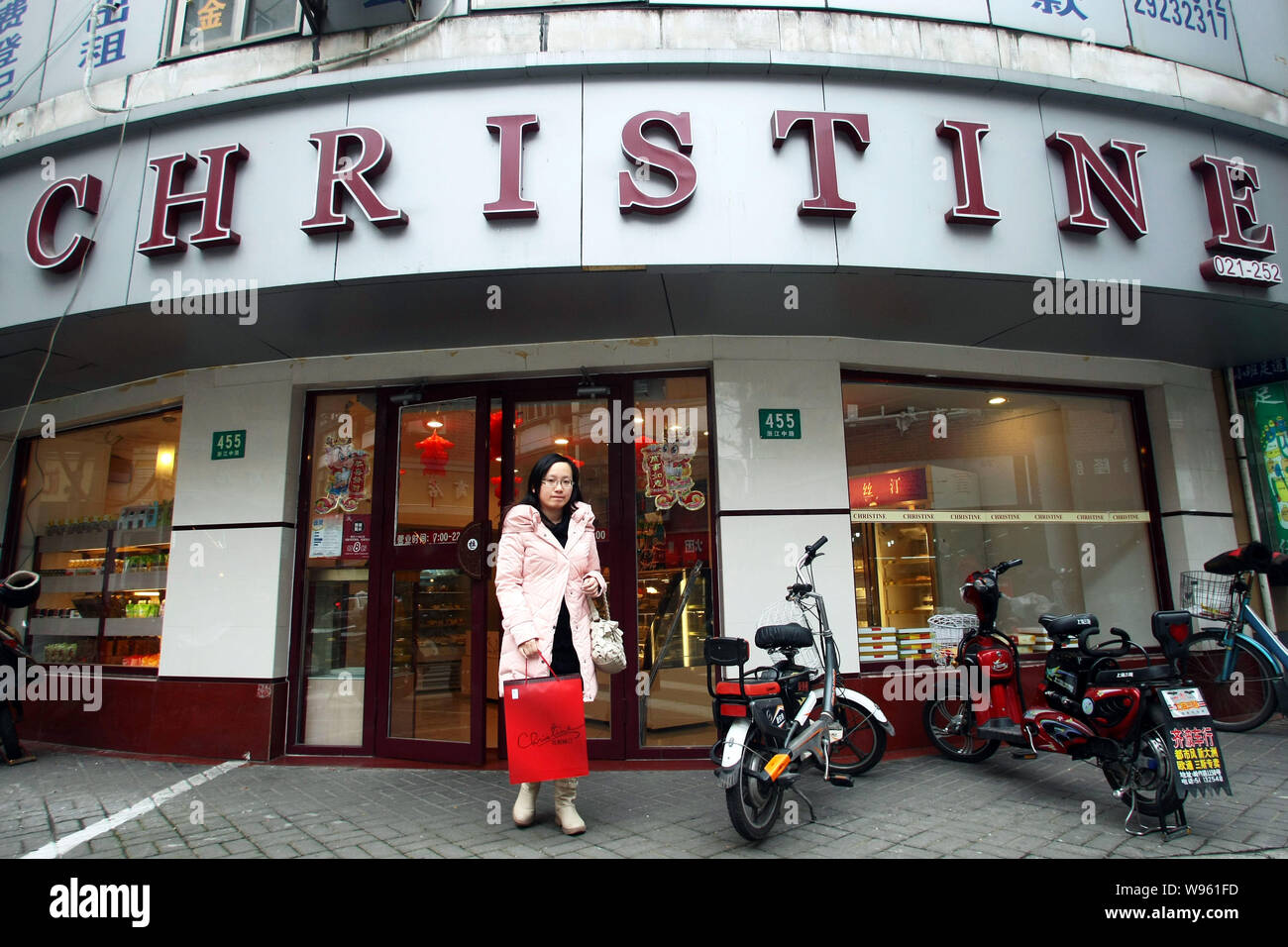 A customer walks out from a Christine chain bakery in Shanghai, China ...