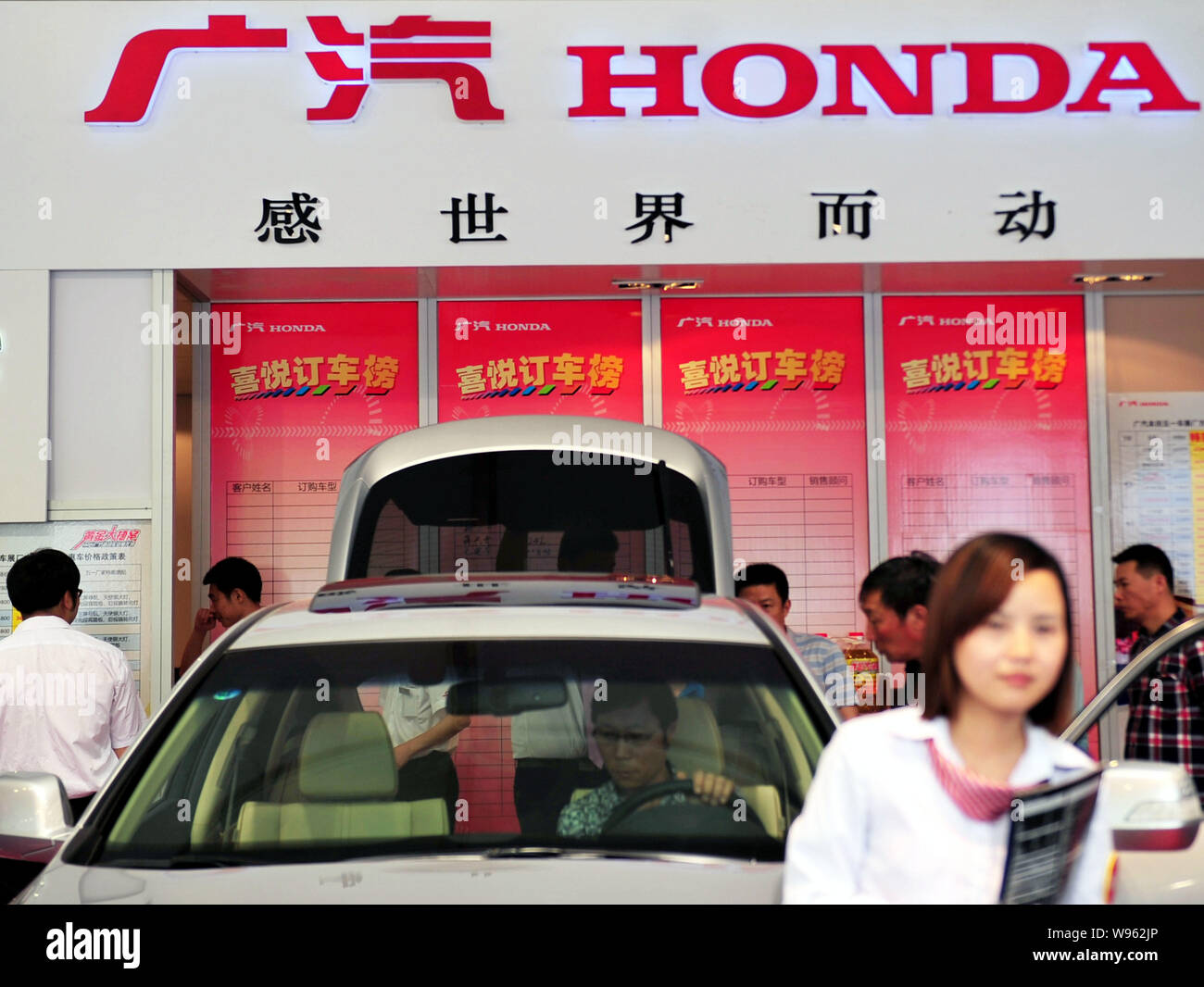 --FILE--Chinese car buyers look at and try out a car at a Honda ...