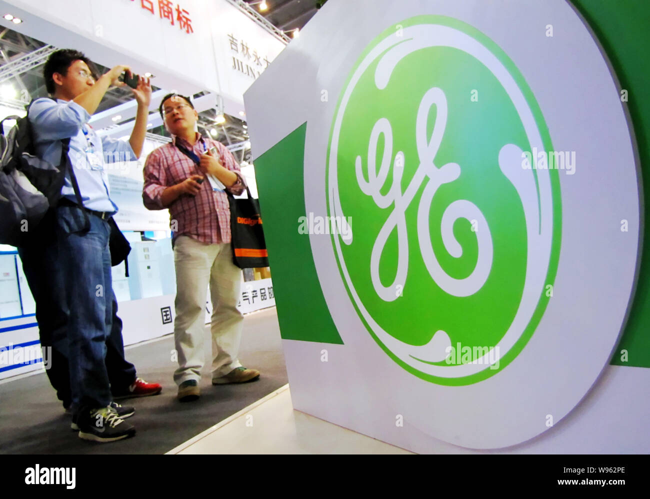--FILE--People visit the stand of GE (General Electric) during a fair ...