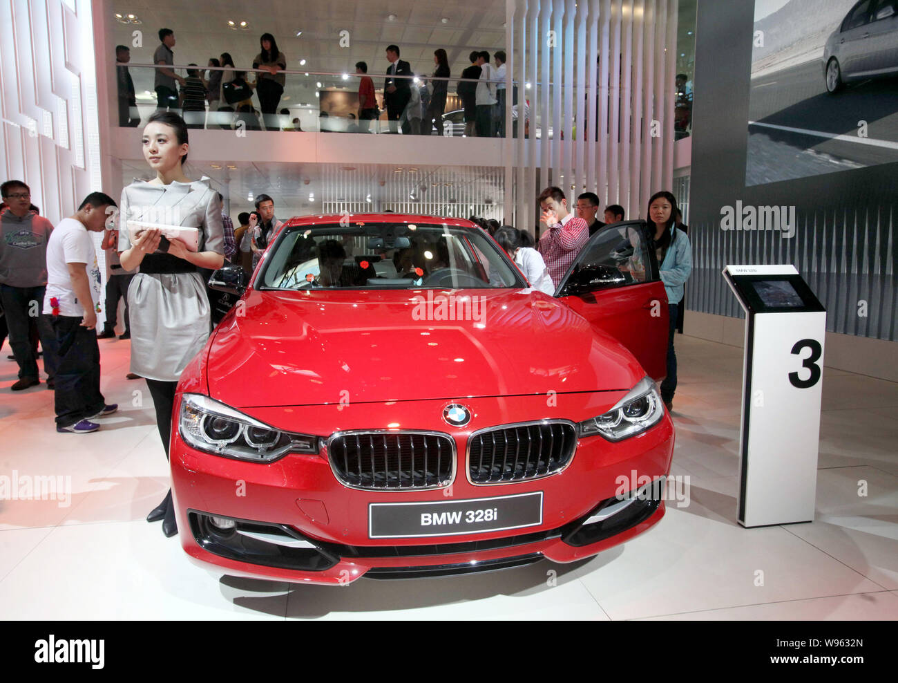 --FILE--Visitors look at a BMW 328i during the 12th Beijing ...