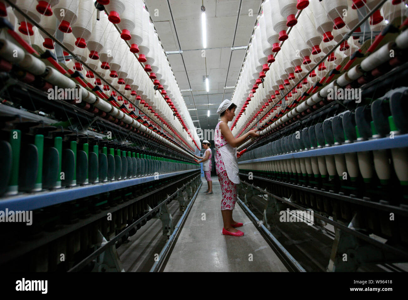 --FILE--Female Chinese workers handle the production of yarn to be exported to southeast Asia on ...