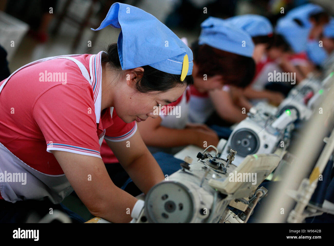 --FILE--Female Chinese workers sew clothes to be exported to Southeast Asia at a garment factory ...