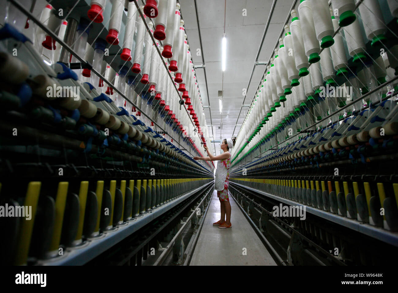 --FILE--A female Chinese worker handles the production of yarn to be exported to southeast Asia ...