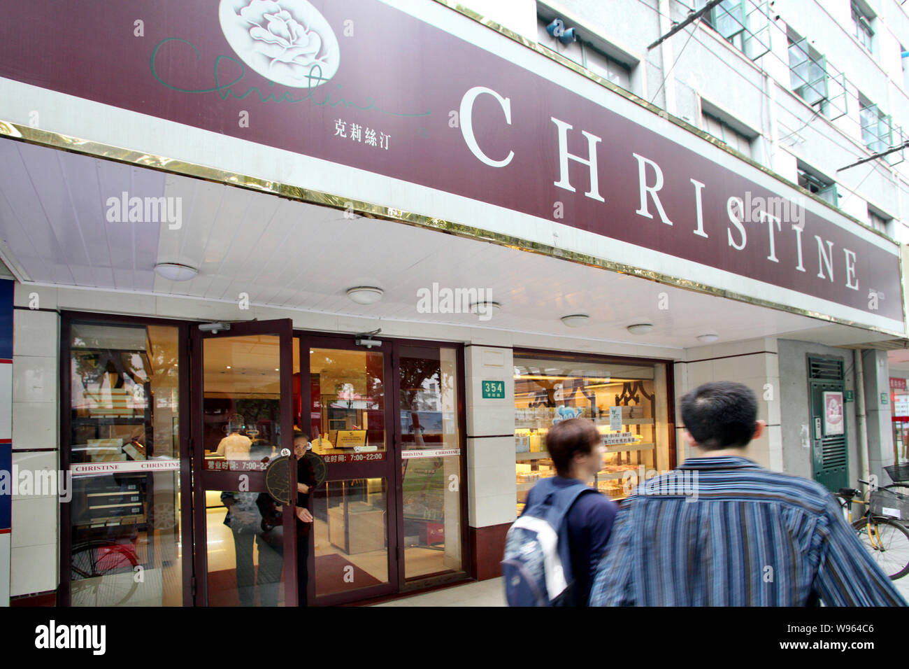 --FILE--Pedestrians walk past a Christine chain bakery in Shanghai ...
