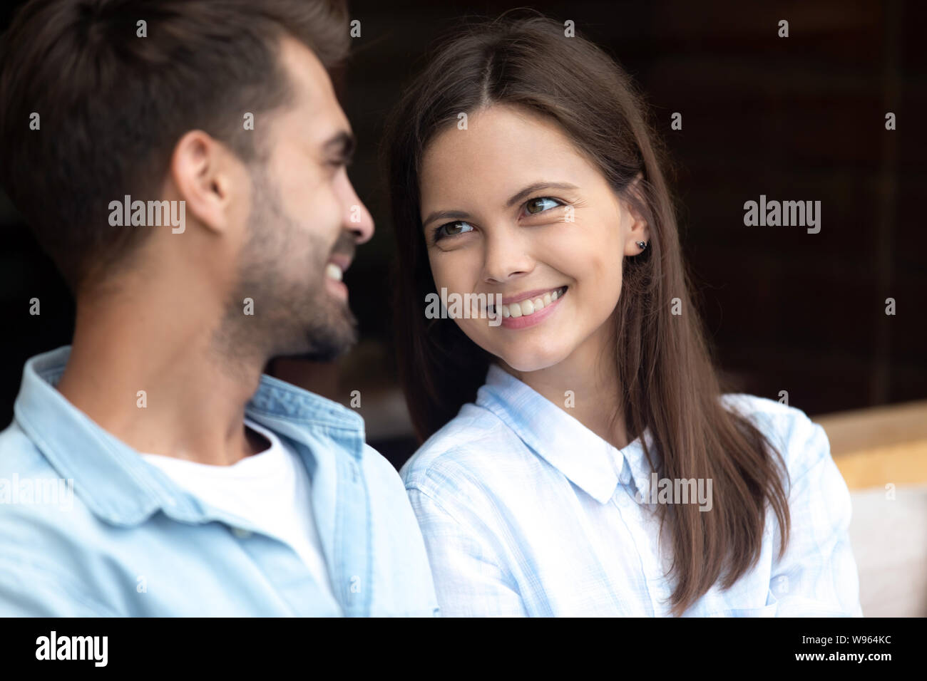 Happy young family look in eyes reconciled after split Stock Photo - Alamy