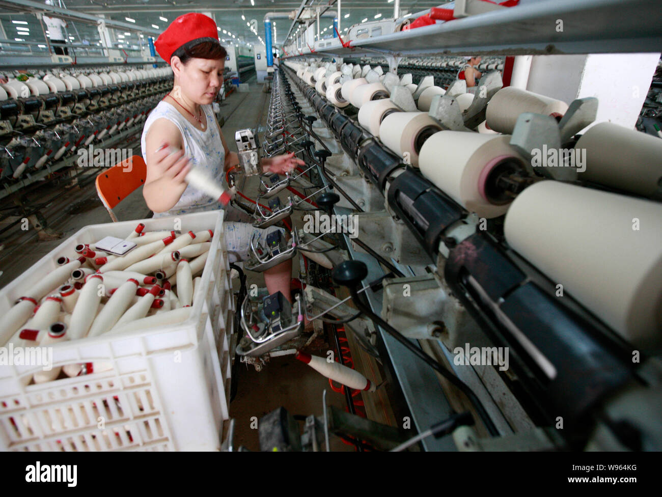 --FILE--A female Chinese worker handles the production of yarn to be exported to southeast Asia ...