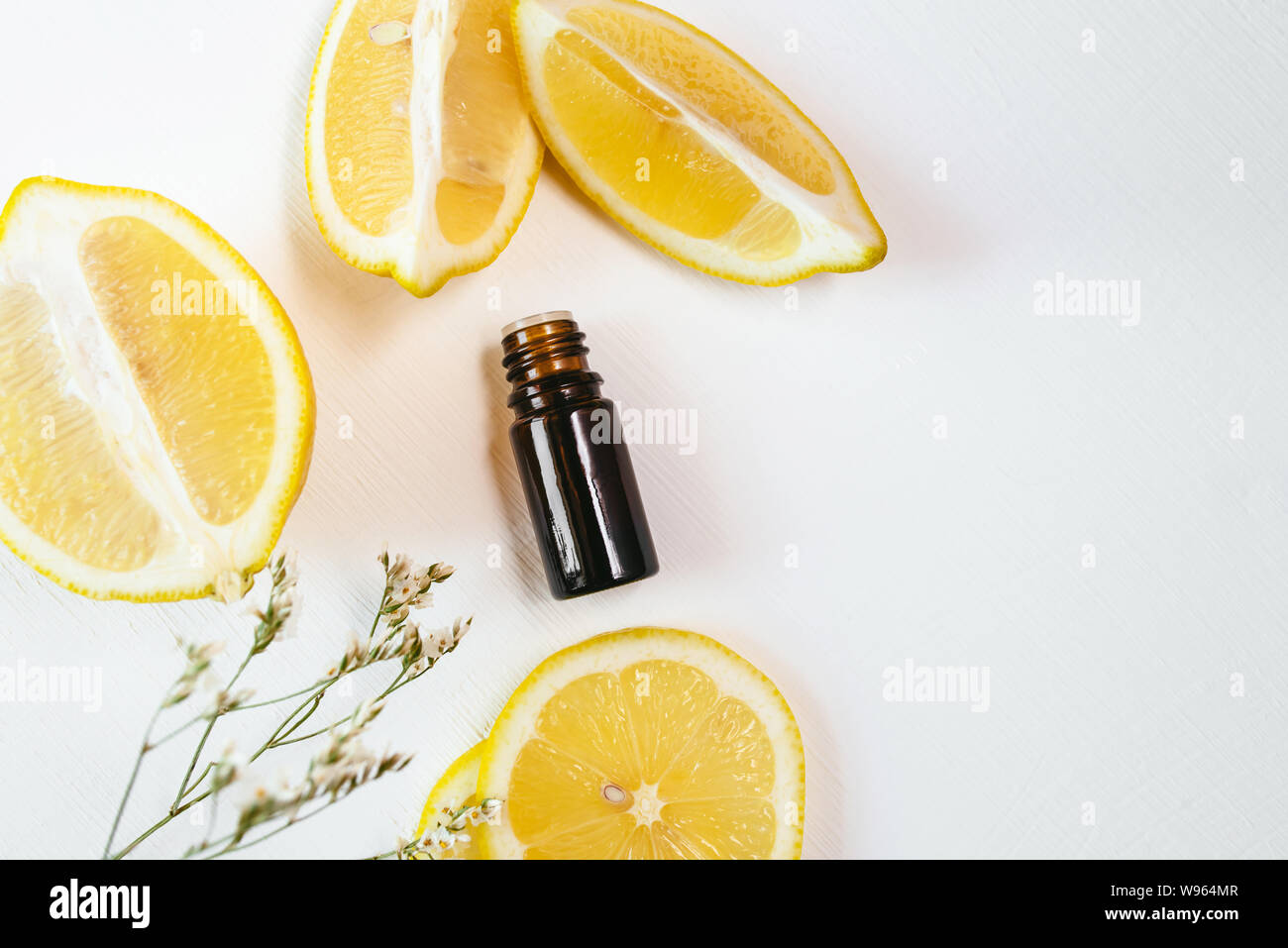 Two bottle of lemon essential oil on white background Stock Photo - Alamy