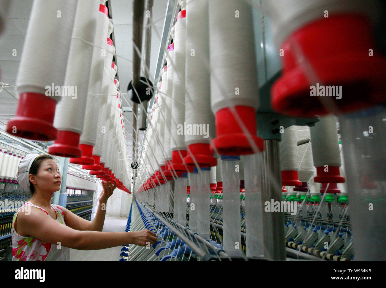 --FILE--A female Chinese worker handles the production of yarn to be exported to Southeast Asia ...