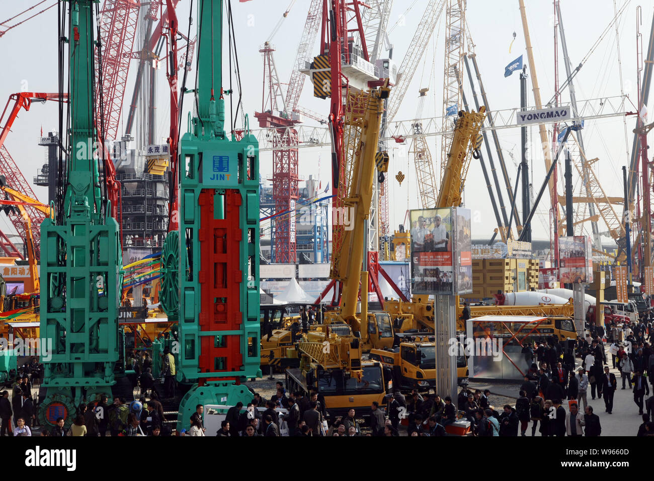 Visitors look at construction and building machineries during the 2012 ...