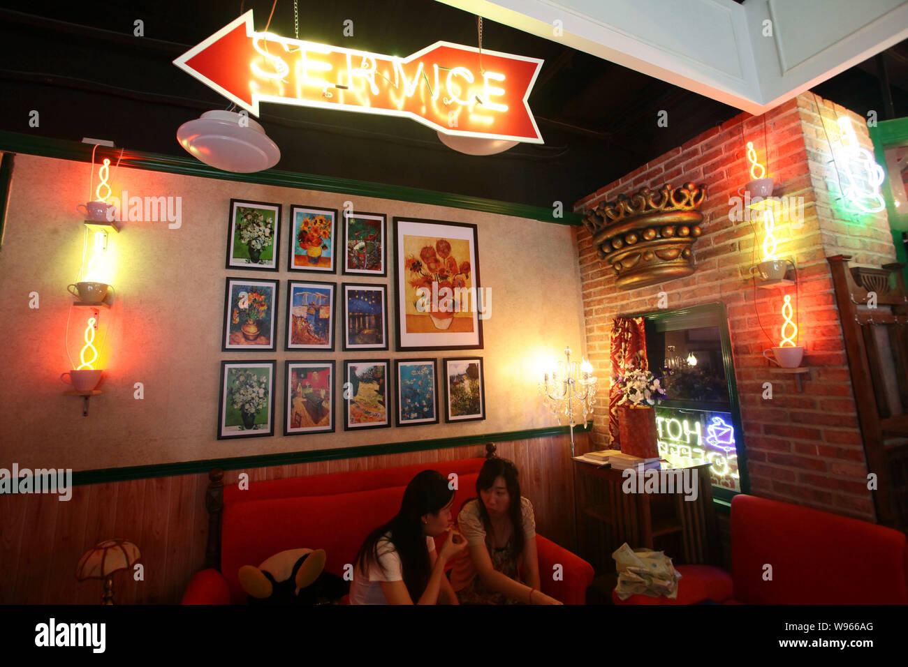 Young women enjoy cakes and coffee in a Central Perk cafe in Shanghai ...