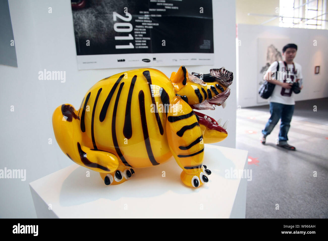 A visitor looks at an artwork during the SH Contemporary art exhibition ...