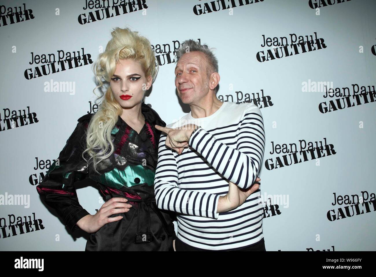 French designer Jean Paul Gautier poses with a model during his fashion ...