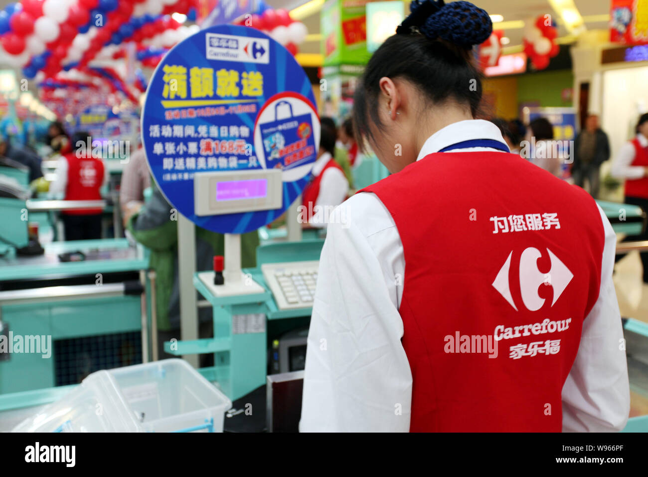 --FILE--Chinese employees work at the checkout counters in a Carrefour ...