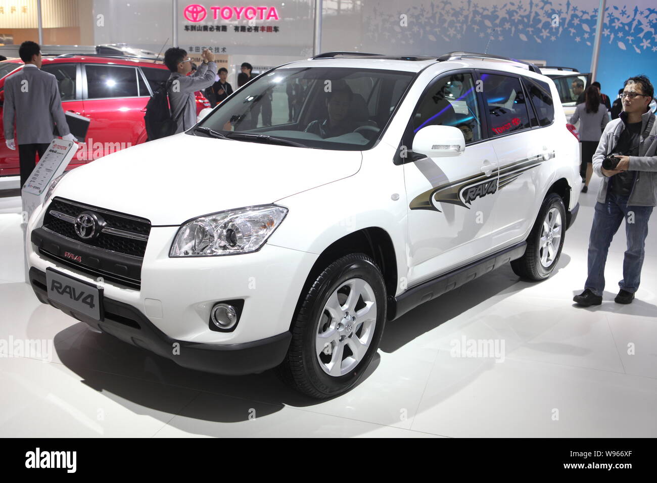 --FILE--Visitors look at a Toyota RAV4 SUV during an auto show in ...