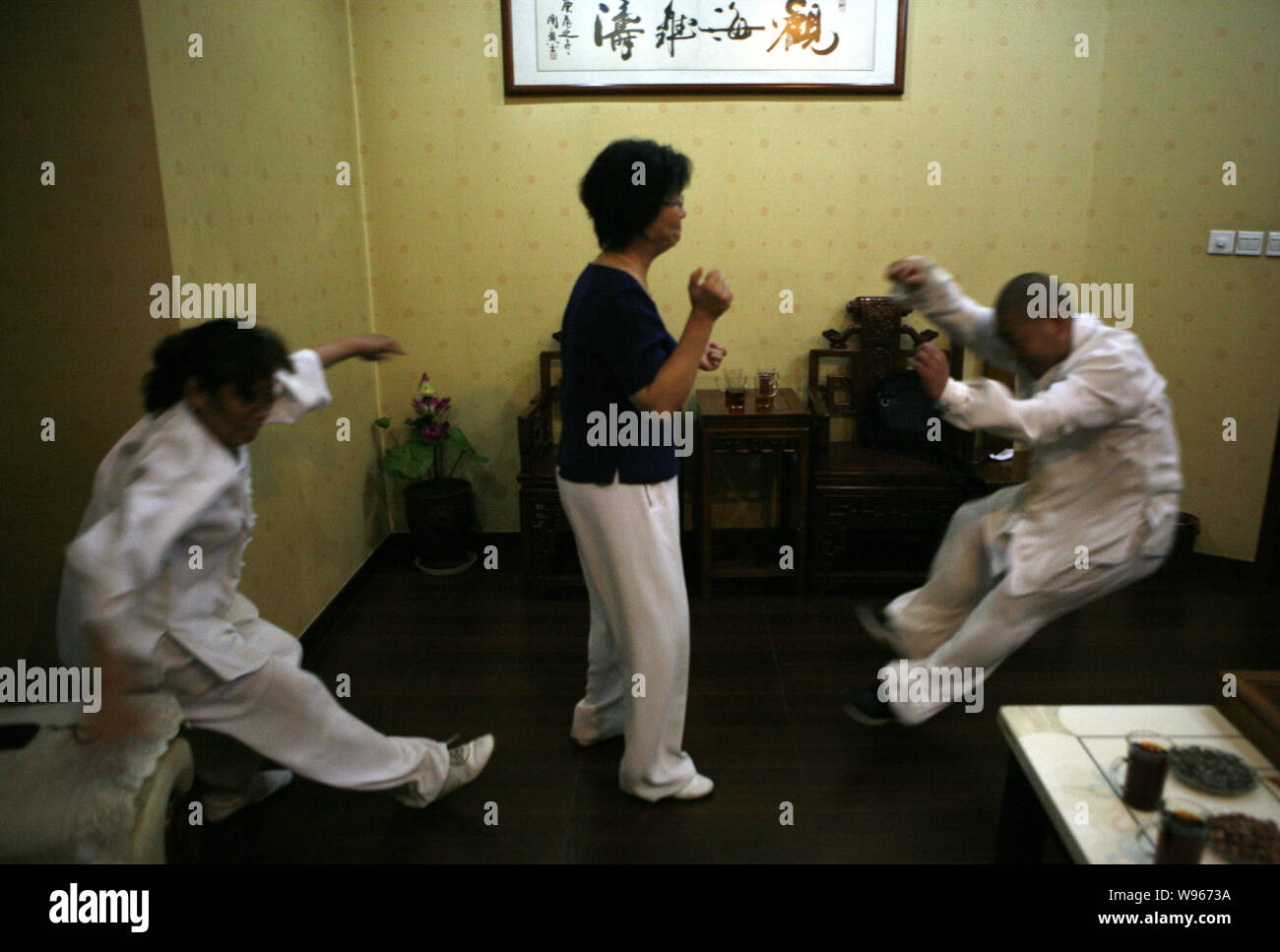 Chinese Tai Chi master Yan Fang (C) demonstrates Pushing Hands, a ...