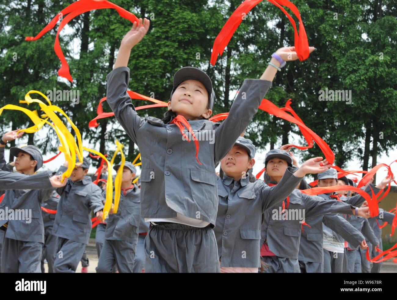 Students wearing uniforms of the Chinese Red Army dance during class ...