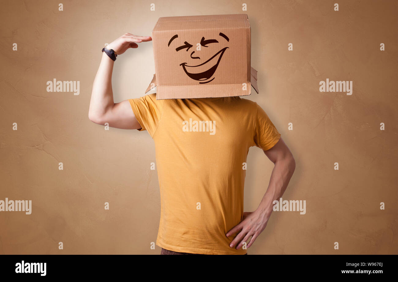 Young boy standing and gesturing with a cardboard box on his head Stock ...