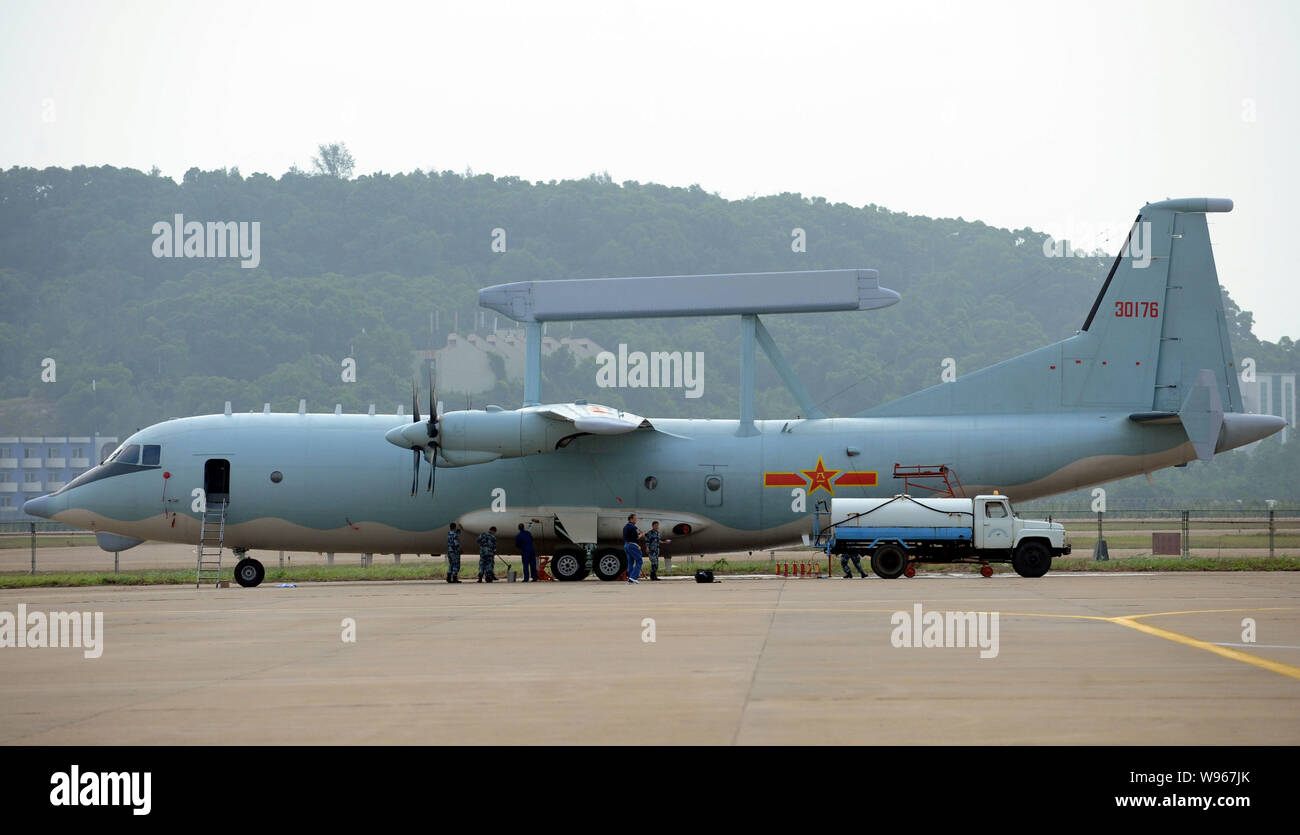 Ground crew members check a KJ-200 Balance Beam airborne early warning ...