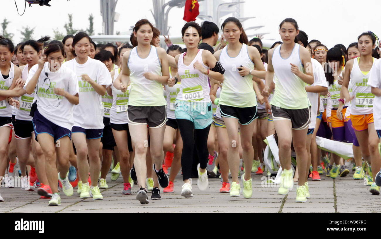 Taiwanese singer and actress Elle Chen Jiahua (M) runs during the Nike ...