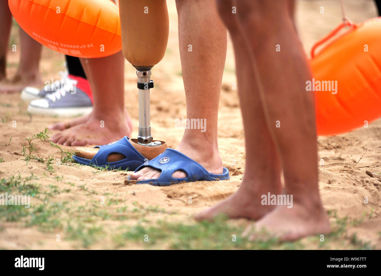21-year-old Xue who lost his right leg and other swimmers stand by at ...