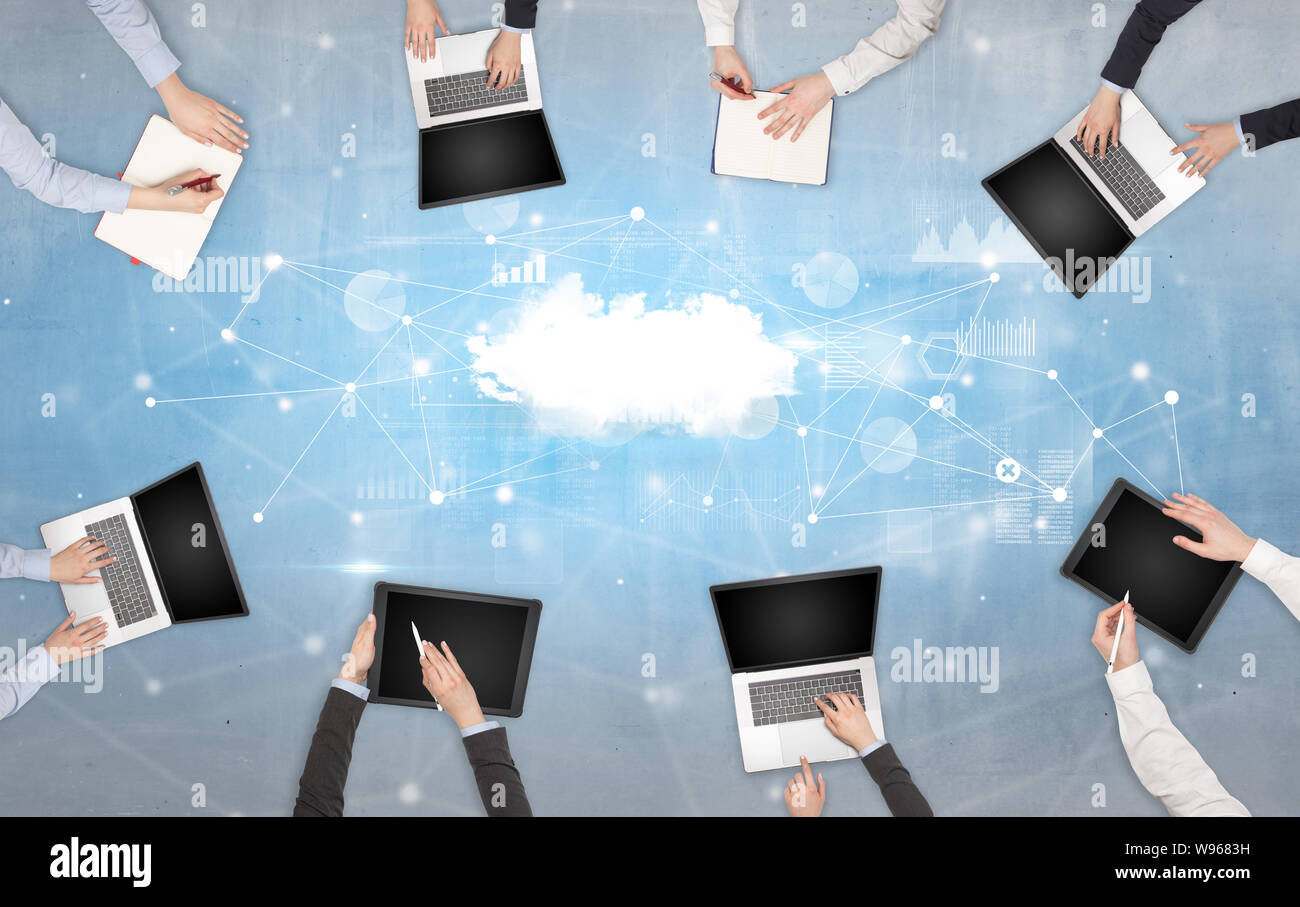 Group of people with devices in hands working on reports with online ...