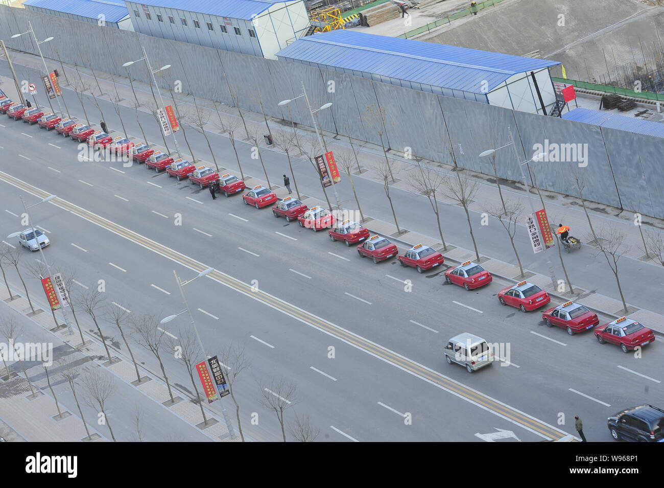 Aerial view of a long queue of taxis waiting to be refueled with ...