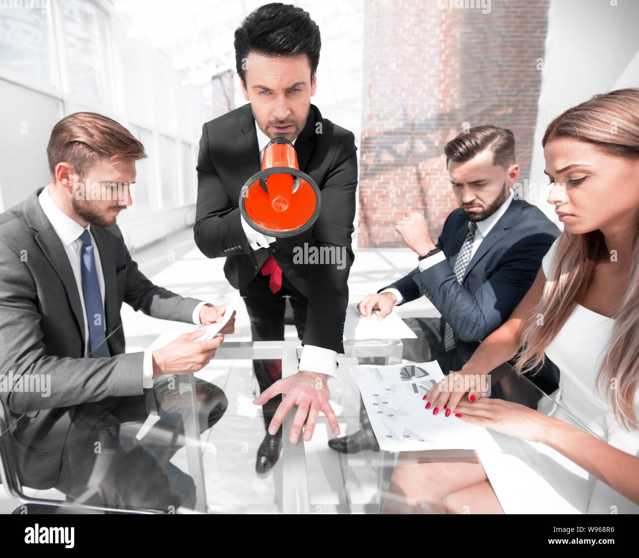 angry Manager with a megaphone at the meeting Stock Photo - Alamy